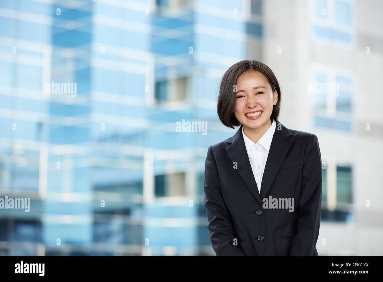 Smiling Woman in Recruit Suit with Background of Building Stock Photo ...