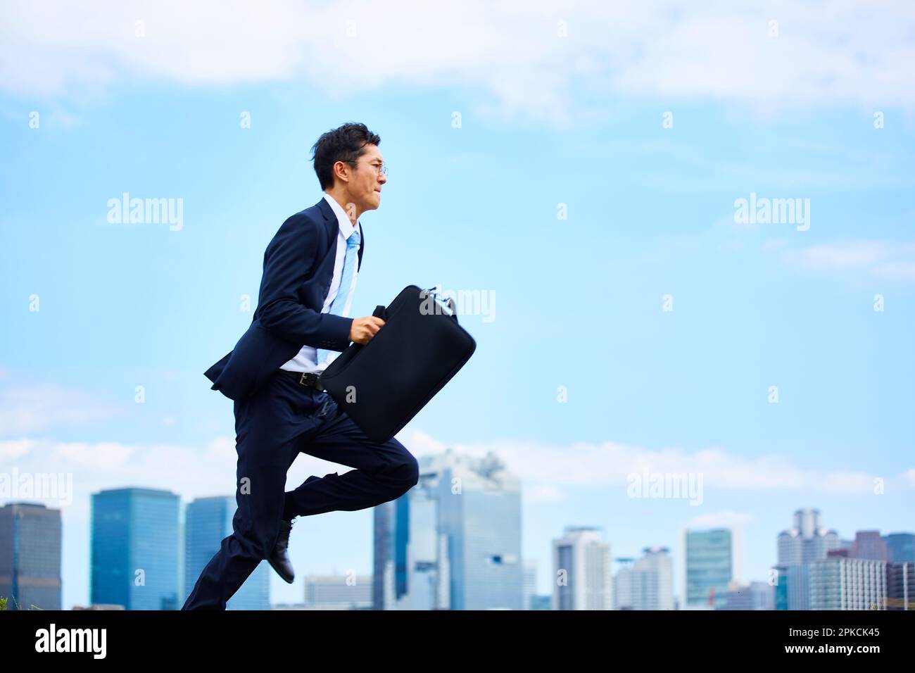Businessman running in suit Stock Photo - Alamy