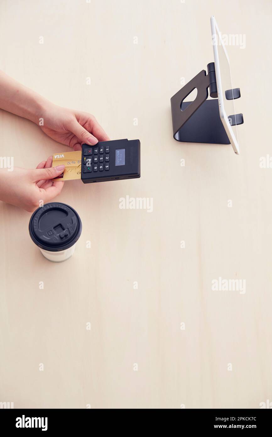 Inserting a credit card into a cashless payment terminal Stock Photo ...