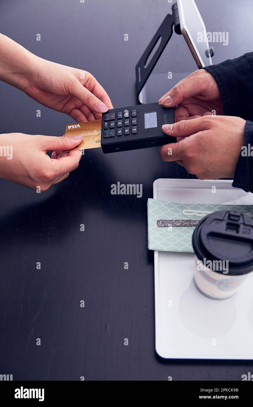 Inserting a credit card into a cashless payment terminal Stock Photo ...