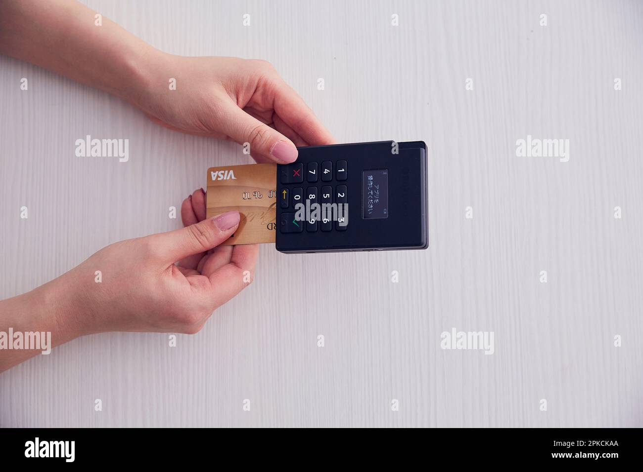 Inserting a credit card into a cashless payment terminal Stock Photo ...