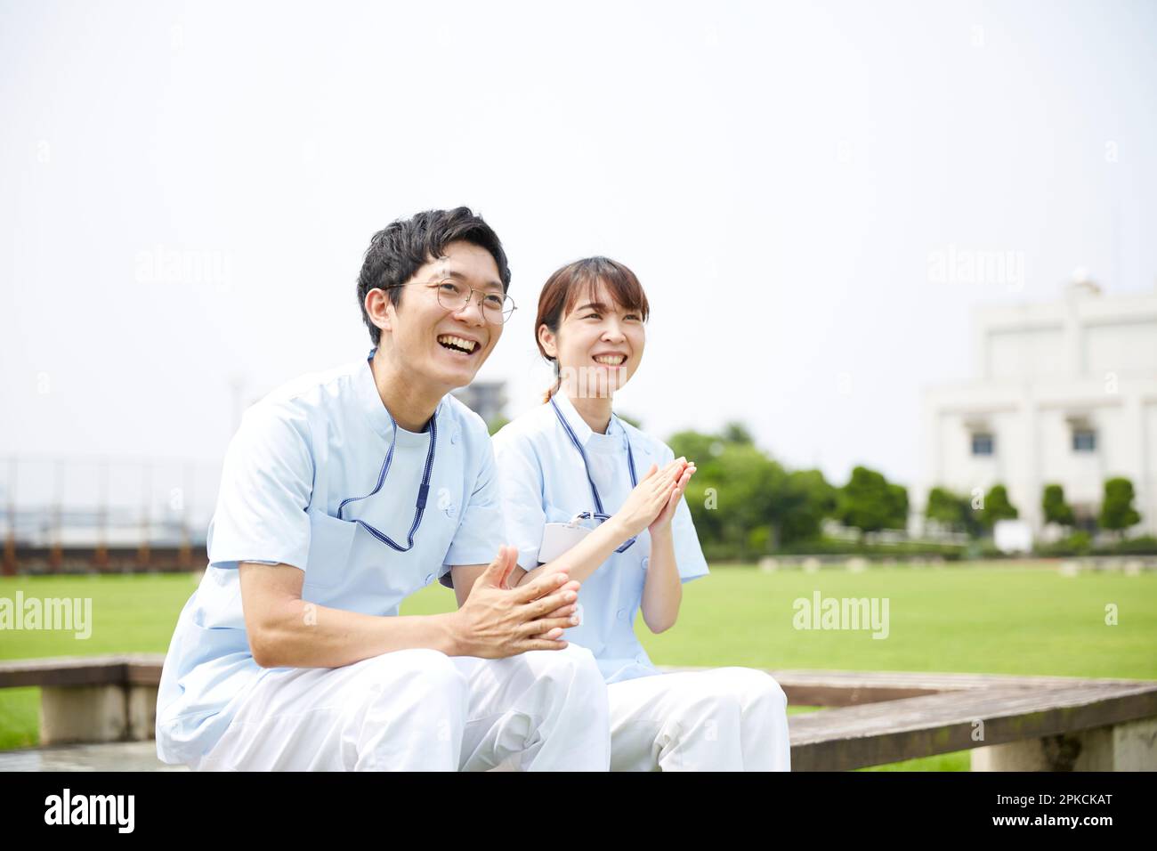 Male and female nurses smiling and talking Stock Photo - Alamy