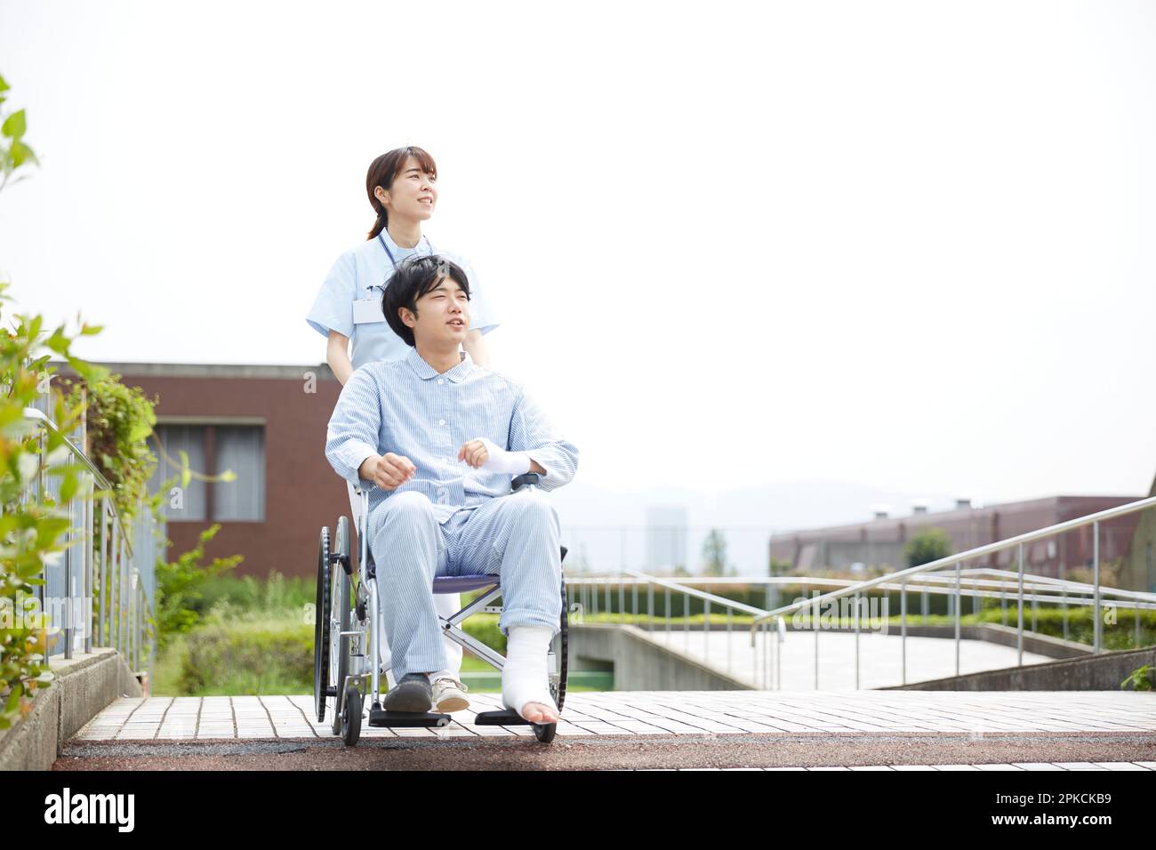 Patient and nurse in wheelchair walking Stock Photo - Alamy