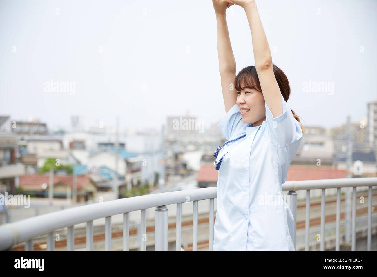 Female Nurse Stretching On Rooftop Stock Photo - Alamy