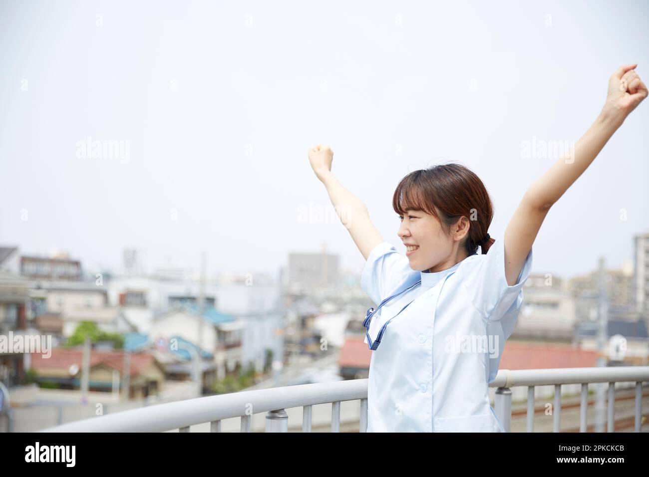 Female Nurse Stretching On Rooftop Stock Photo - Alamy