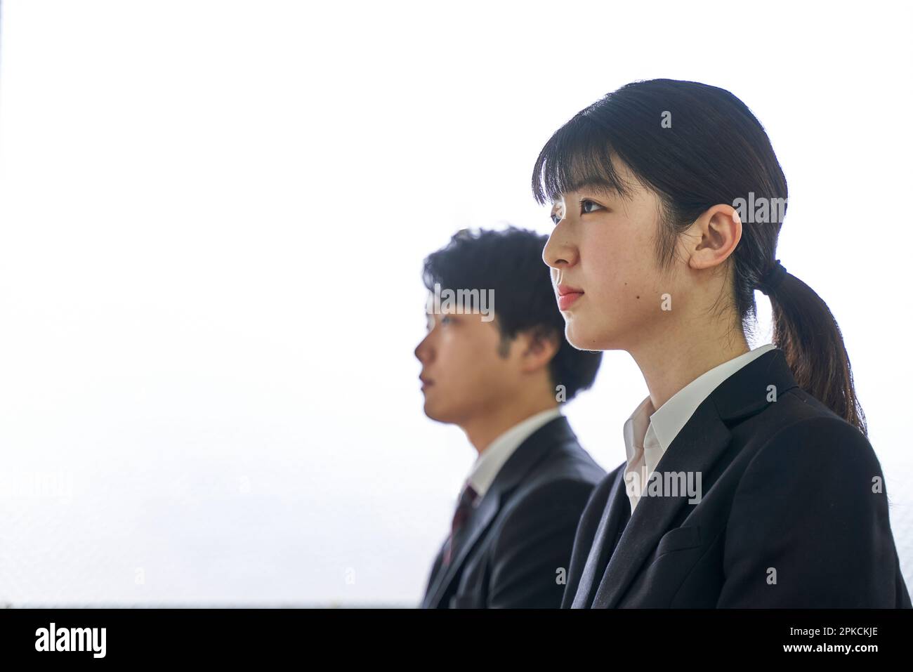 Serious-looking male and female job hunters conducting a group ...