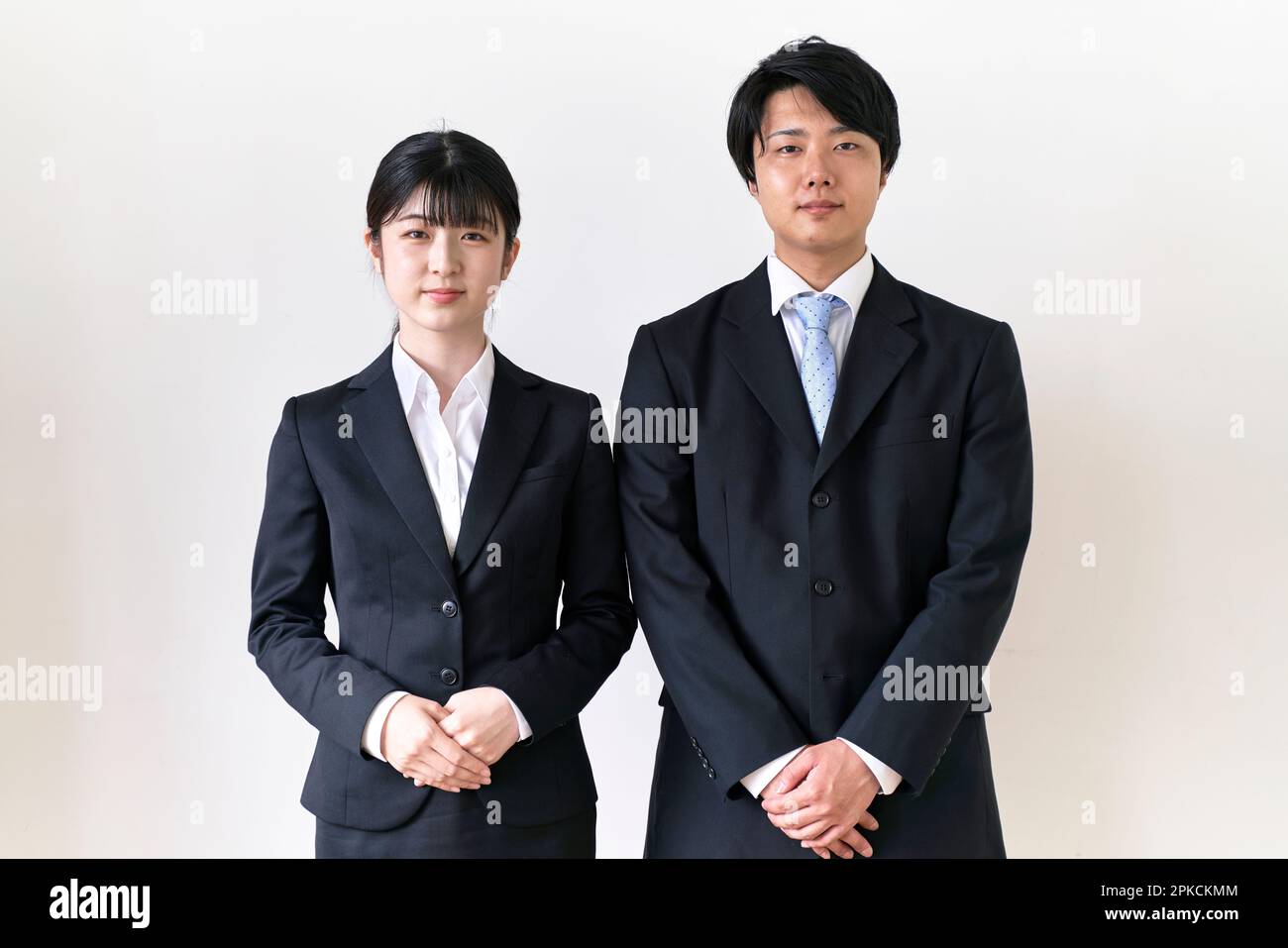 Male and female job hunters with their hands folded in front of them ...