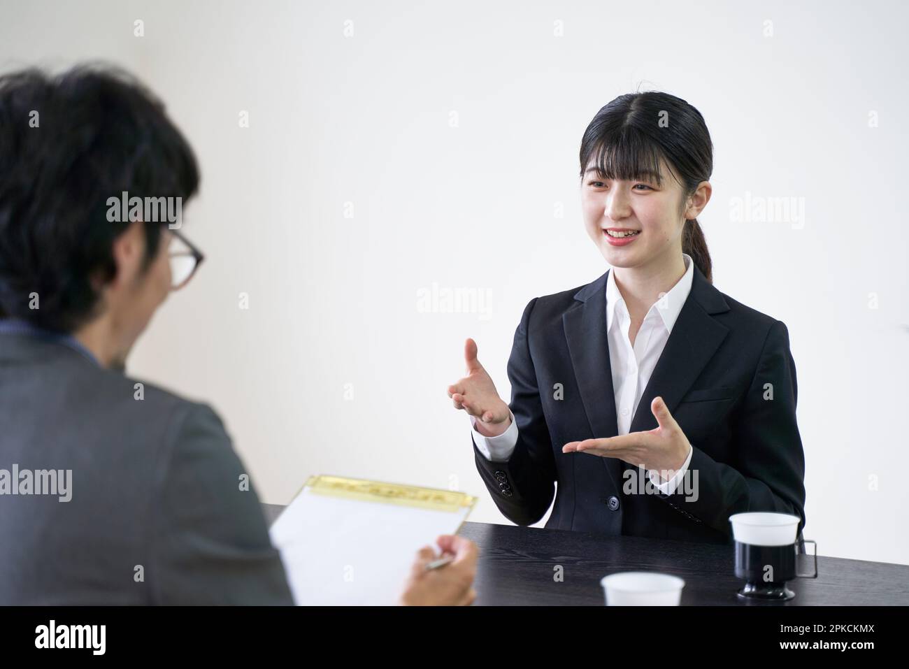 Female job hunter talking with interviewer Stock Photo - Alamy