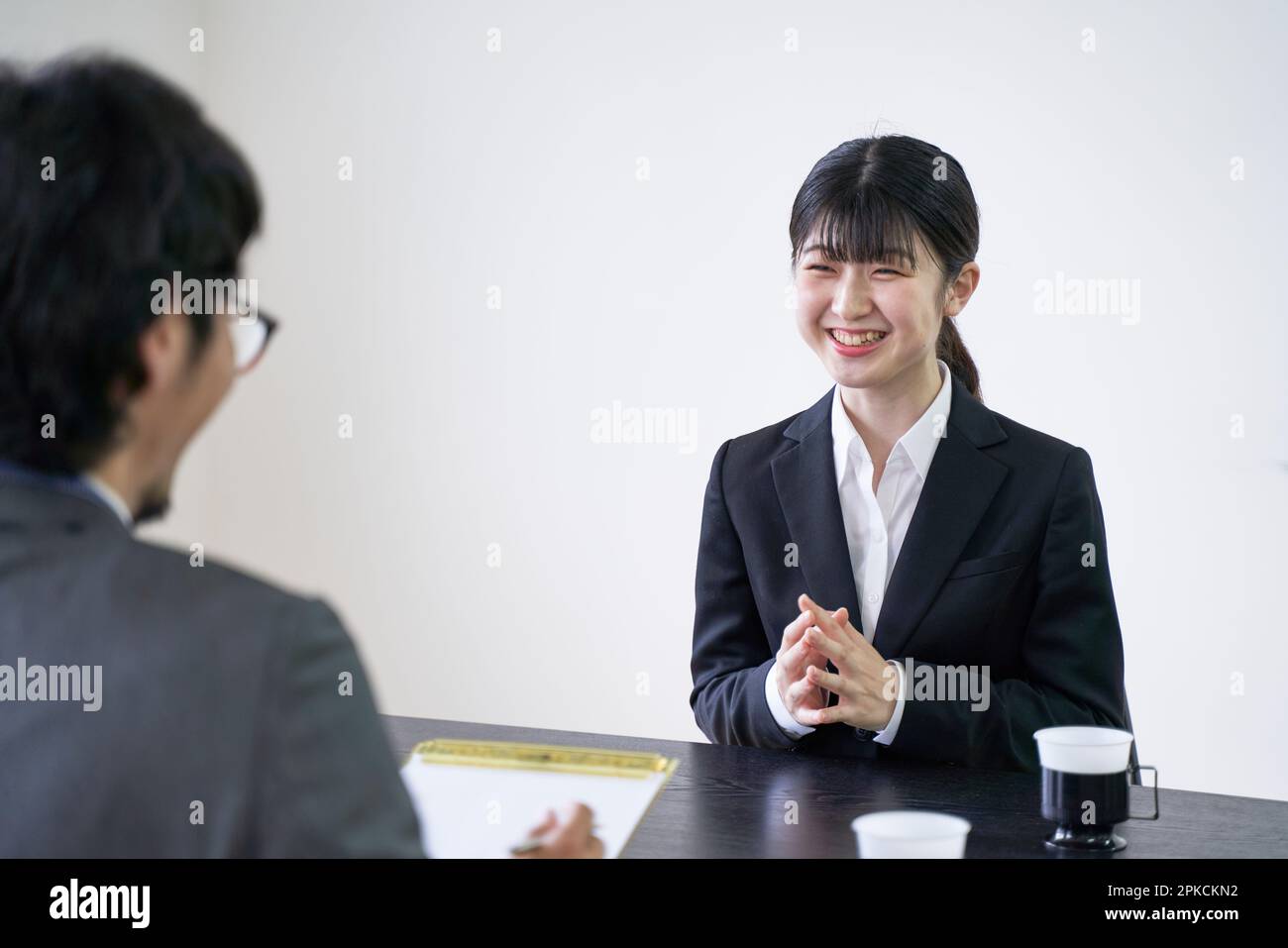 Female job hunter talking with interviewer Stock Photo - Alamy