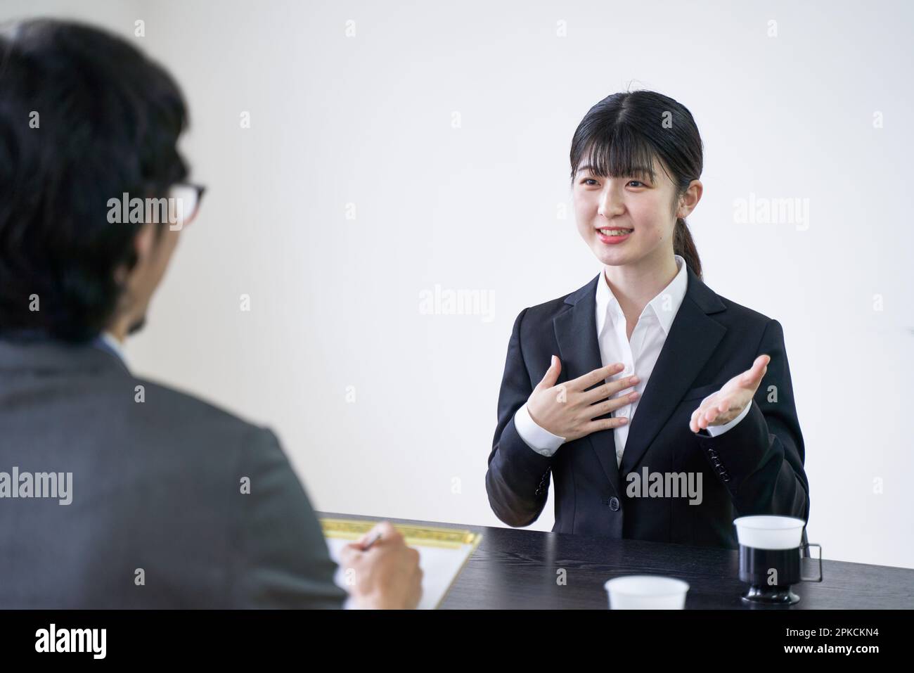 Female job hunter talking with interviewer Stock Photo - Alamy