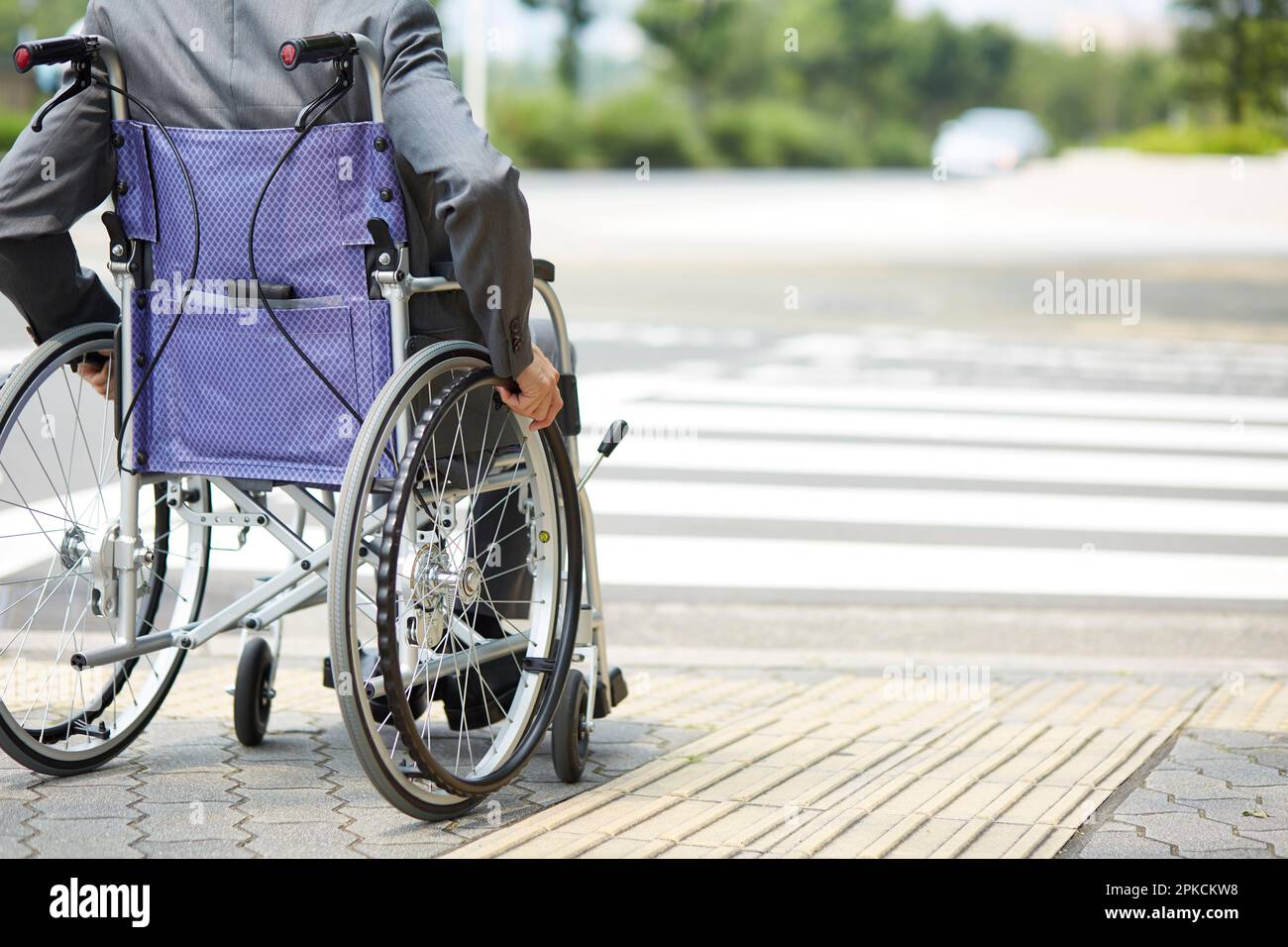 Disabled riding wheelchair in hi-res stock photography and images - Alamy