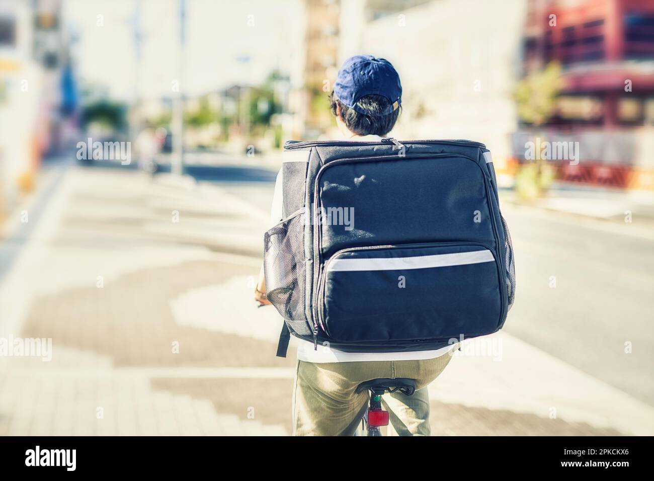 Back view of food delivery man with bicycle Stock Photo - Alamy