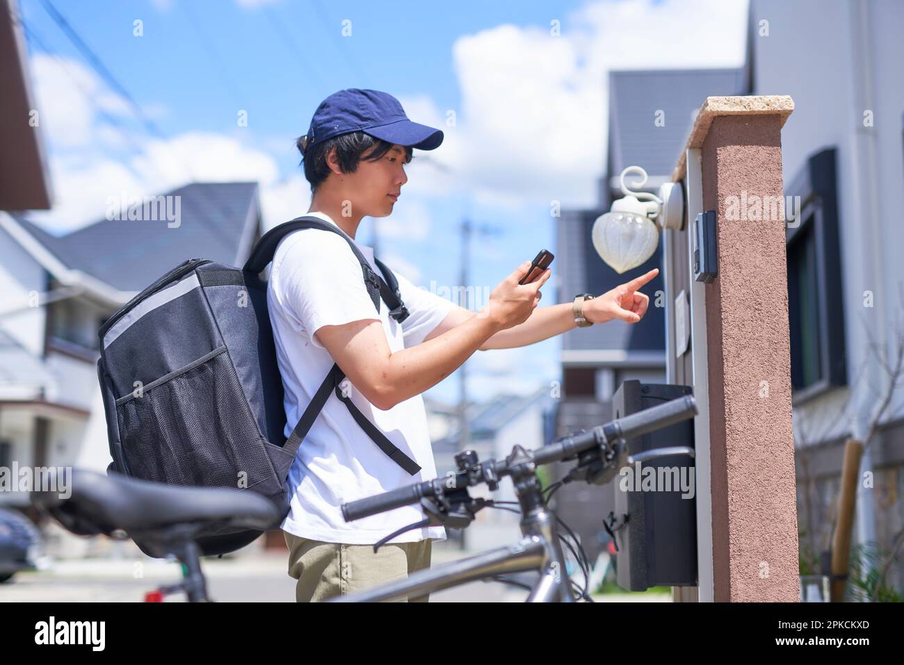 Food Delivery Man Pushing House Chime Stock Photo - Alamy