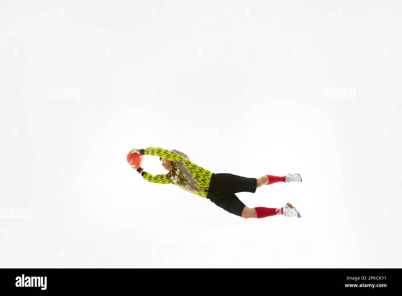 Goalkeeper jumping out to stop the ball Stock Photo - Alamy