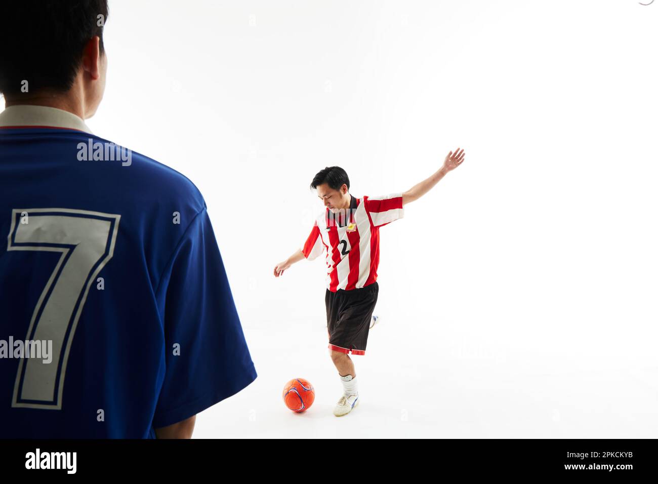 Person kicking a soccer ball and defending a goal in a penalty shootout ...