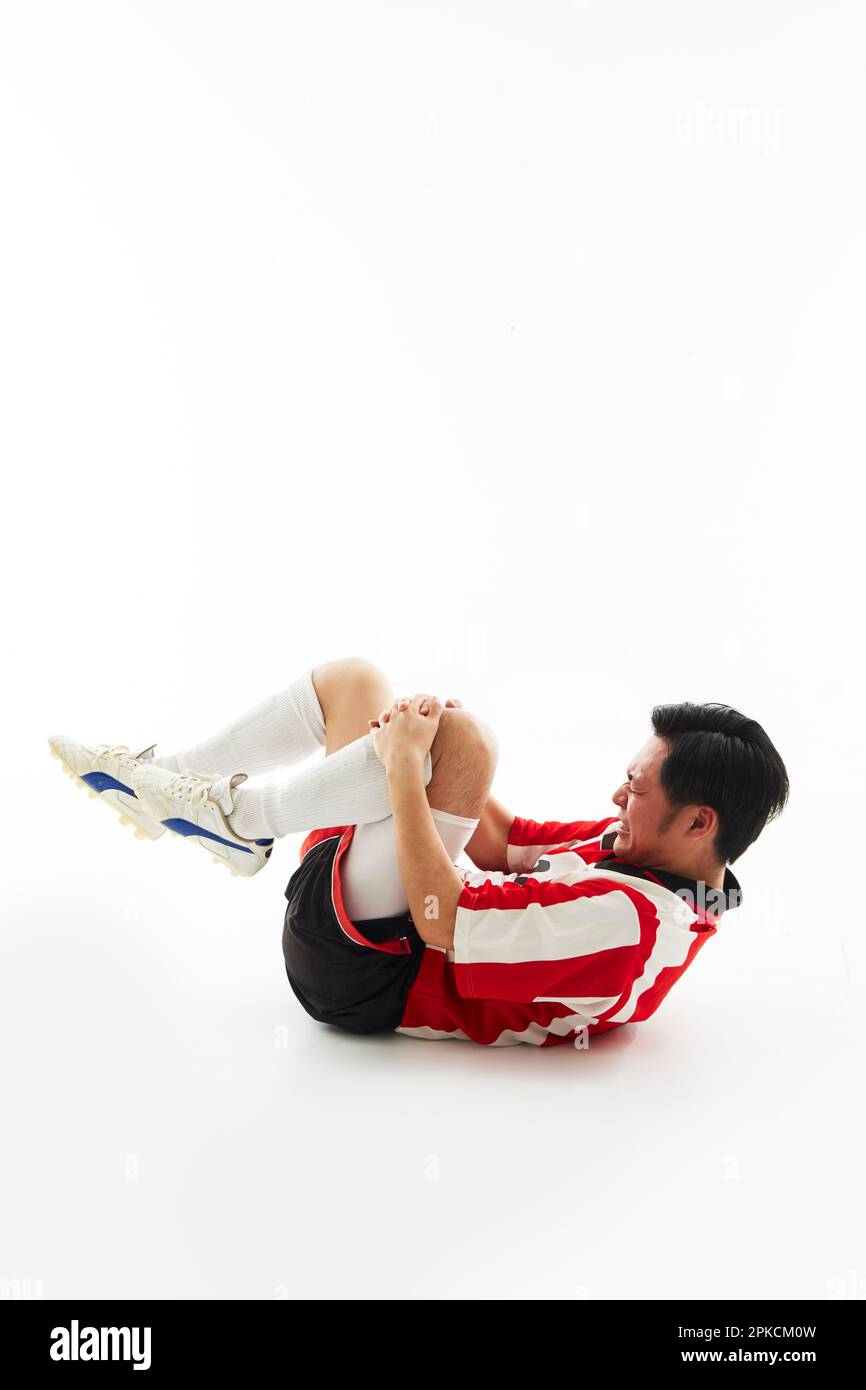Soccer player with leg injury Stock Photo - Alamy
