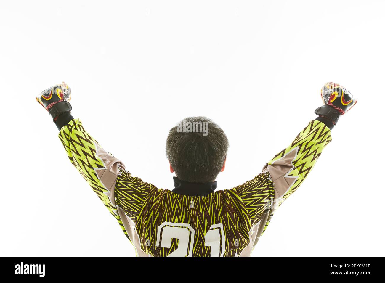 Goalkeeper with hands outstretched and fists up Stock Photo - Alamy