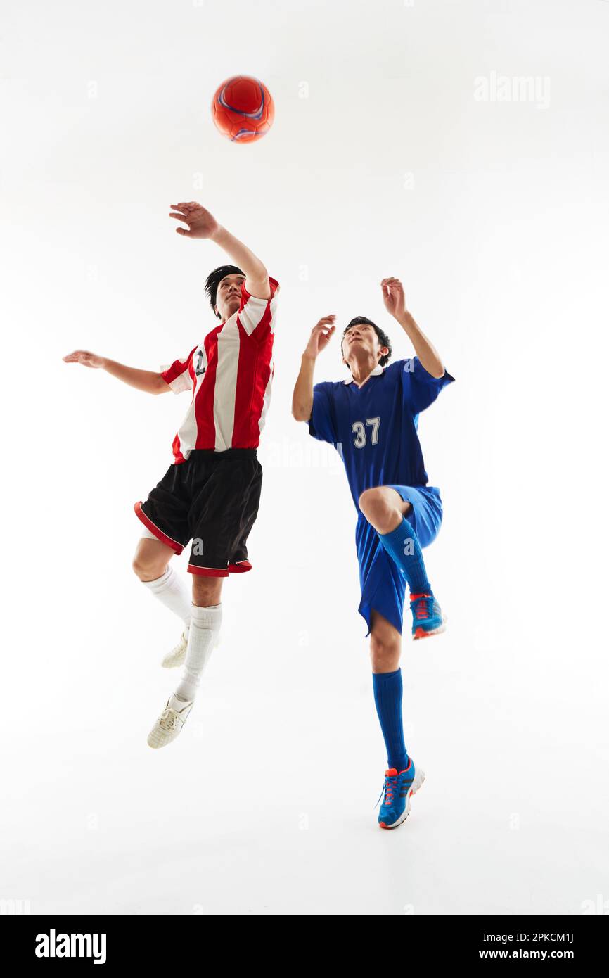 Soccer player competing with a header Stock Photo - Alamy