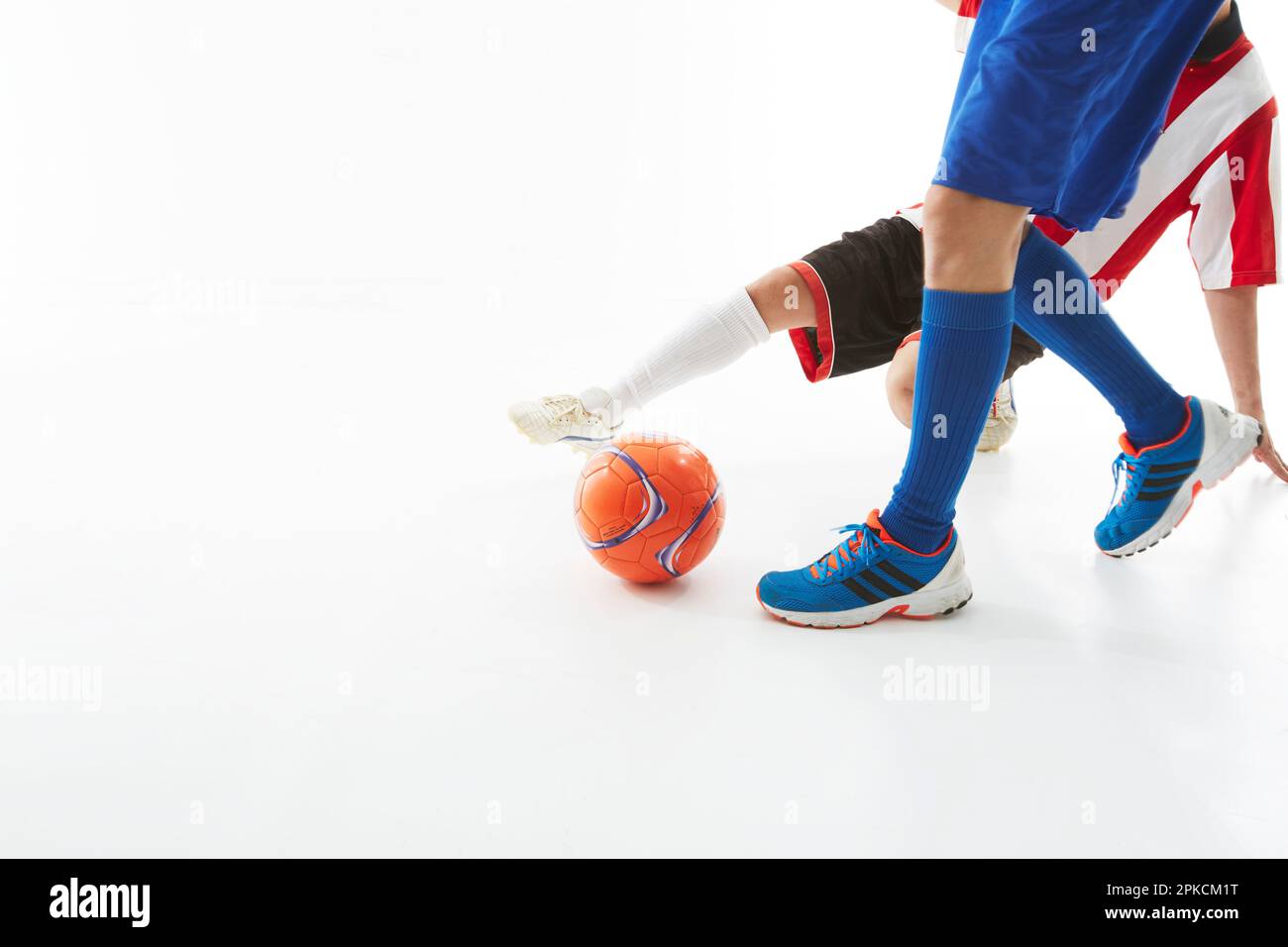 Soccer player sliding to cut off opponent's ball Stock Photo - Alamy