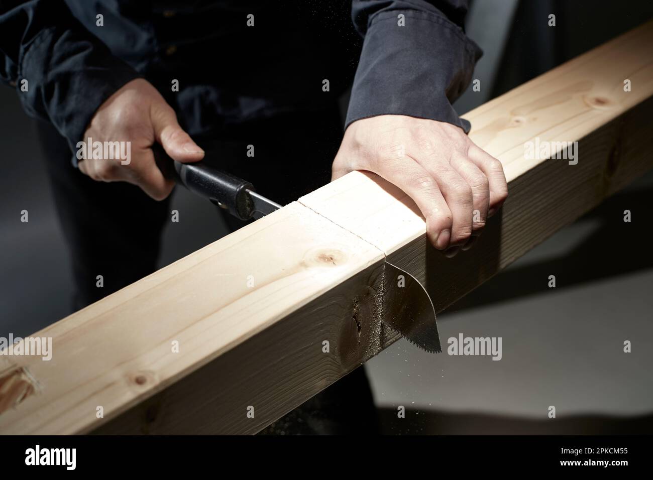 Man's hand cutting timber Stock Photo - Alamy