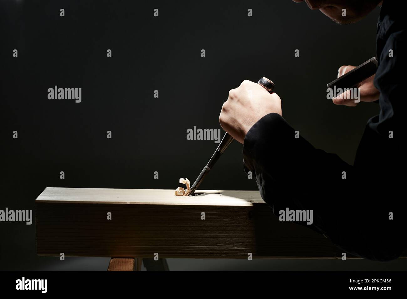 Male hand carving timber Stock Photo - Alamy