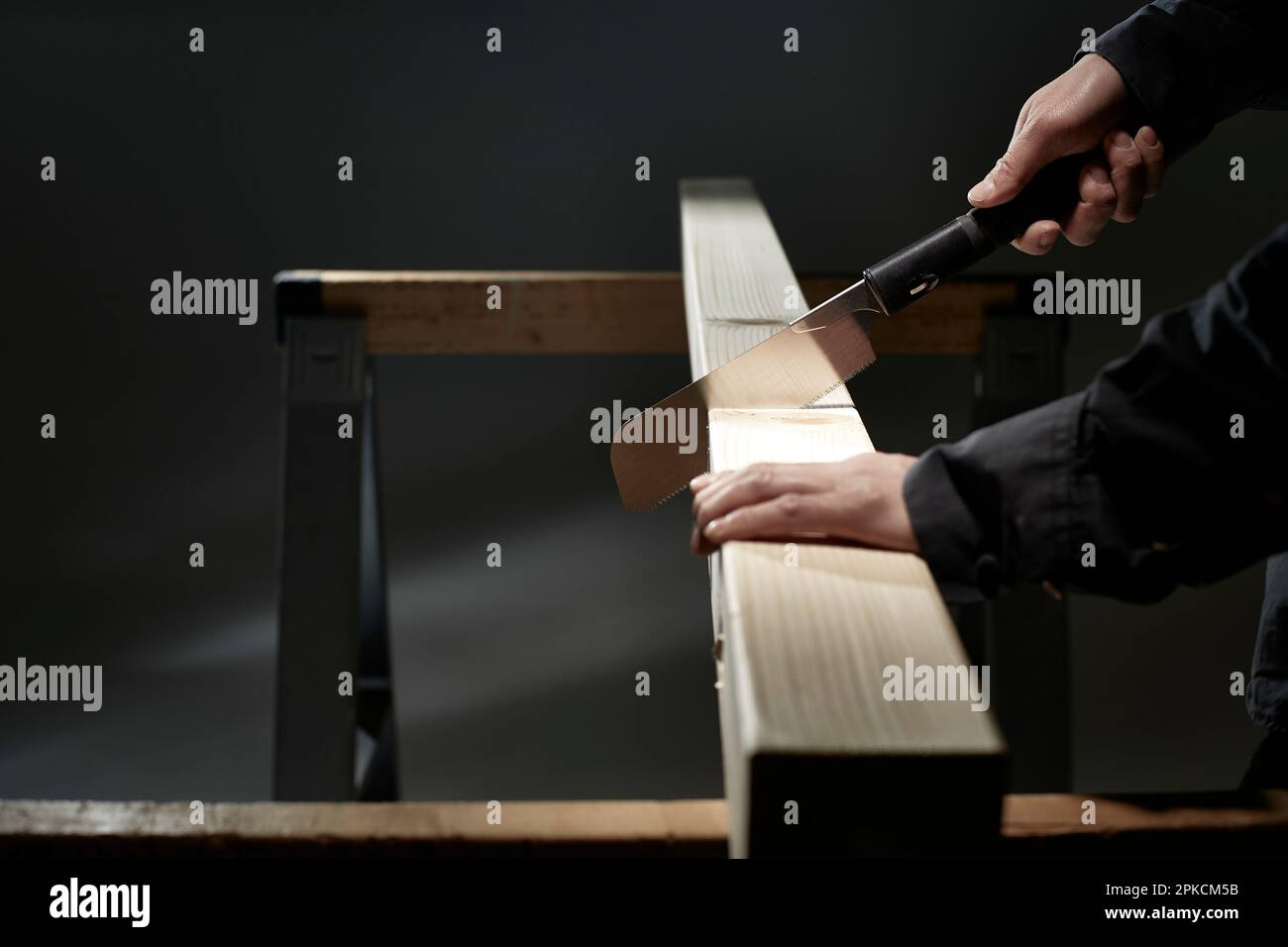 Man's hand cutting timber Stock Photo - Alamy