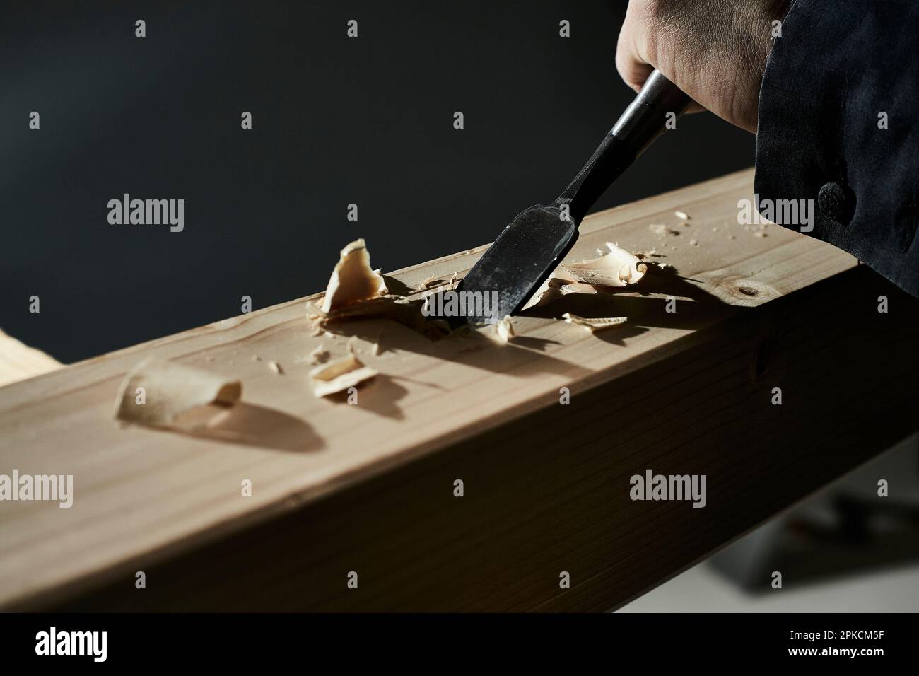 Male hand carving timber Stock Photo - Alamy