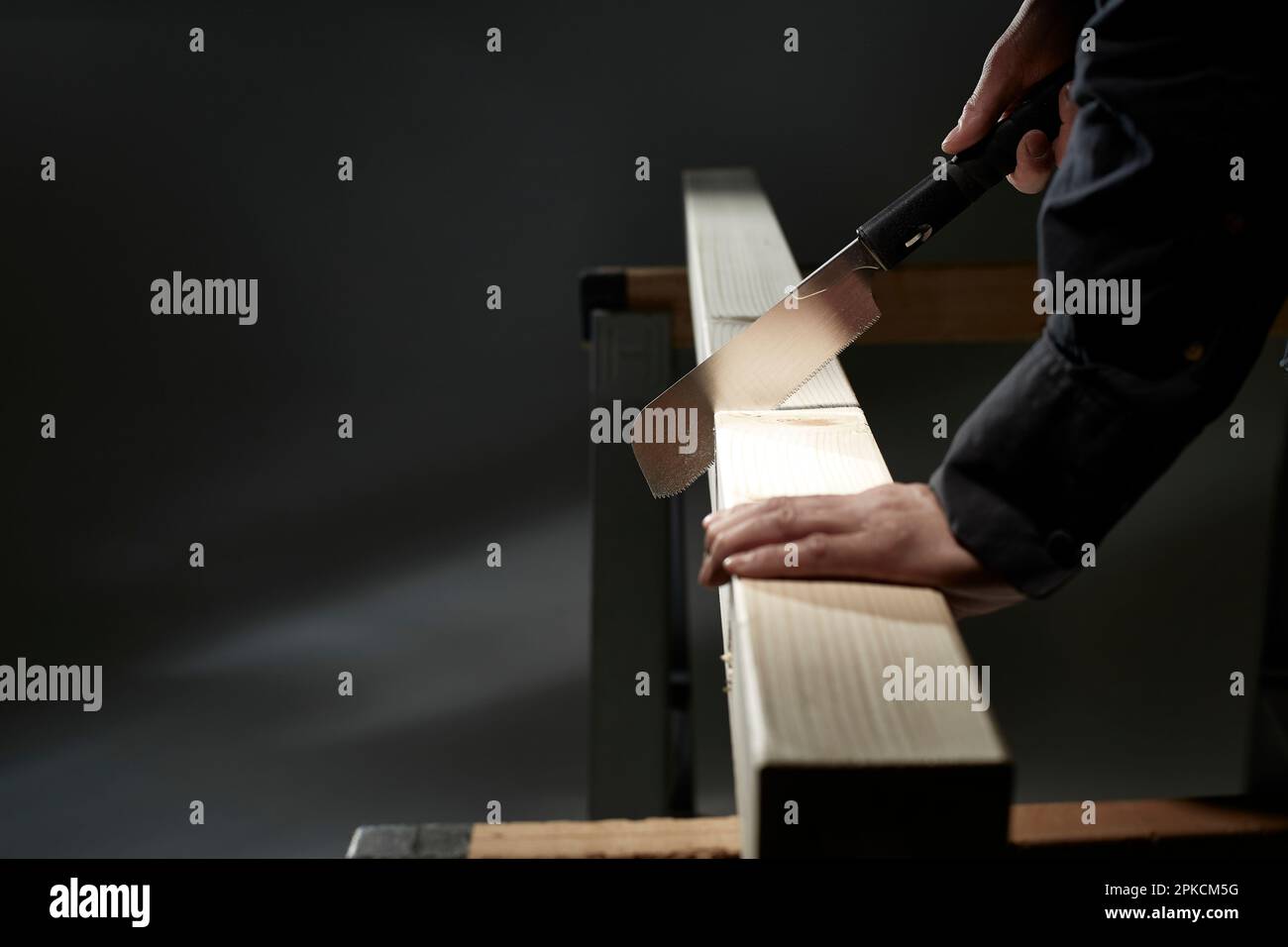 Man's hand cutting timber Stock Photo - Alamy