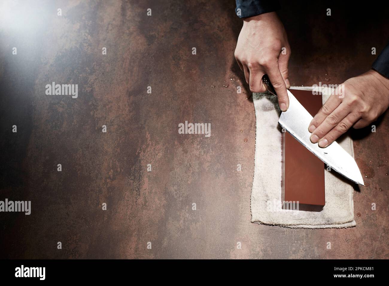 Man's hand sharpening a kitchen knife Stock Photo - Alamy