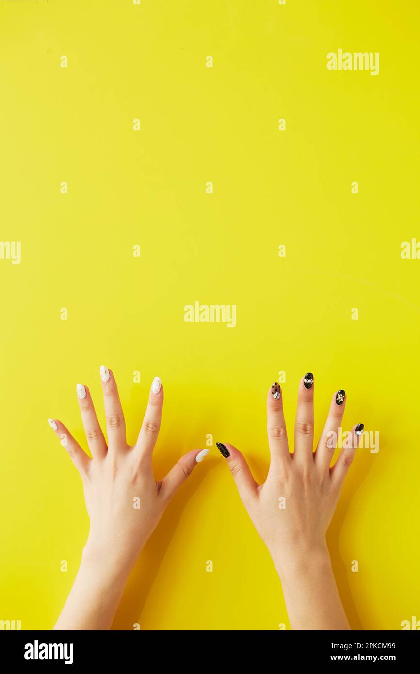 Woman's hand with par on yellow background Stock Photo - Alamy