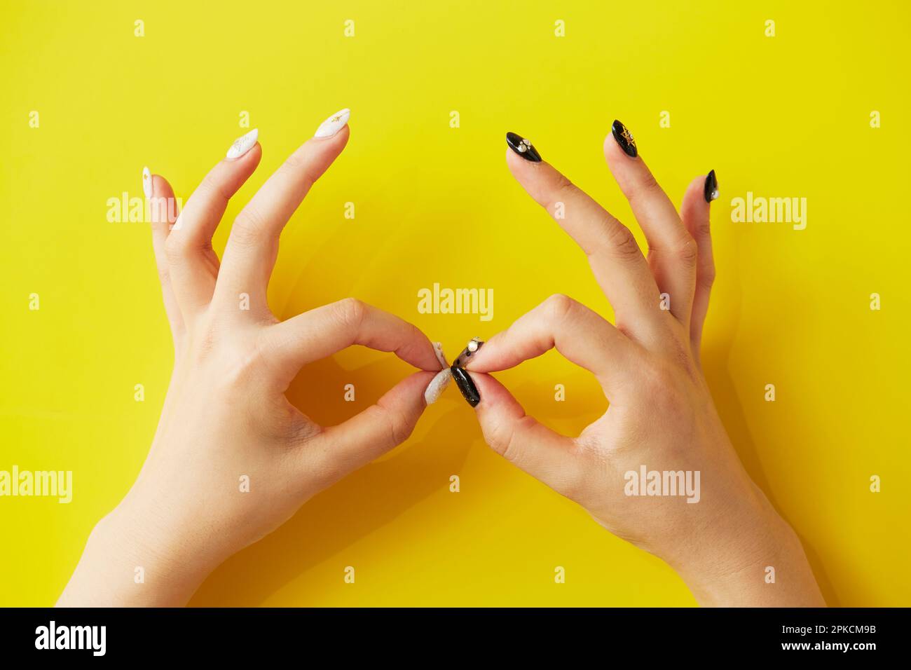 Woman's hand with OK sign on yellow background Stock Photo - Alamy