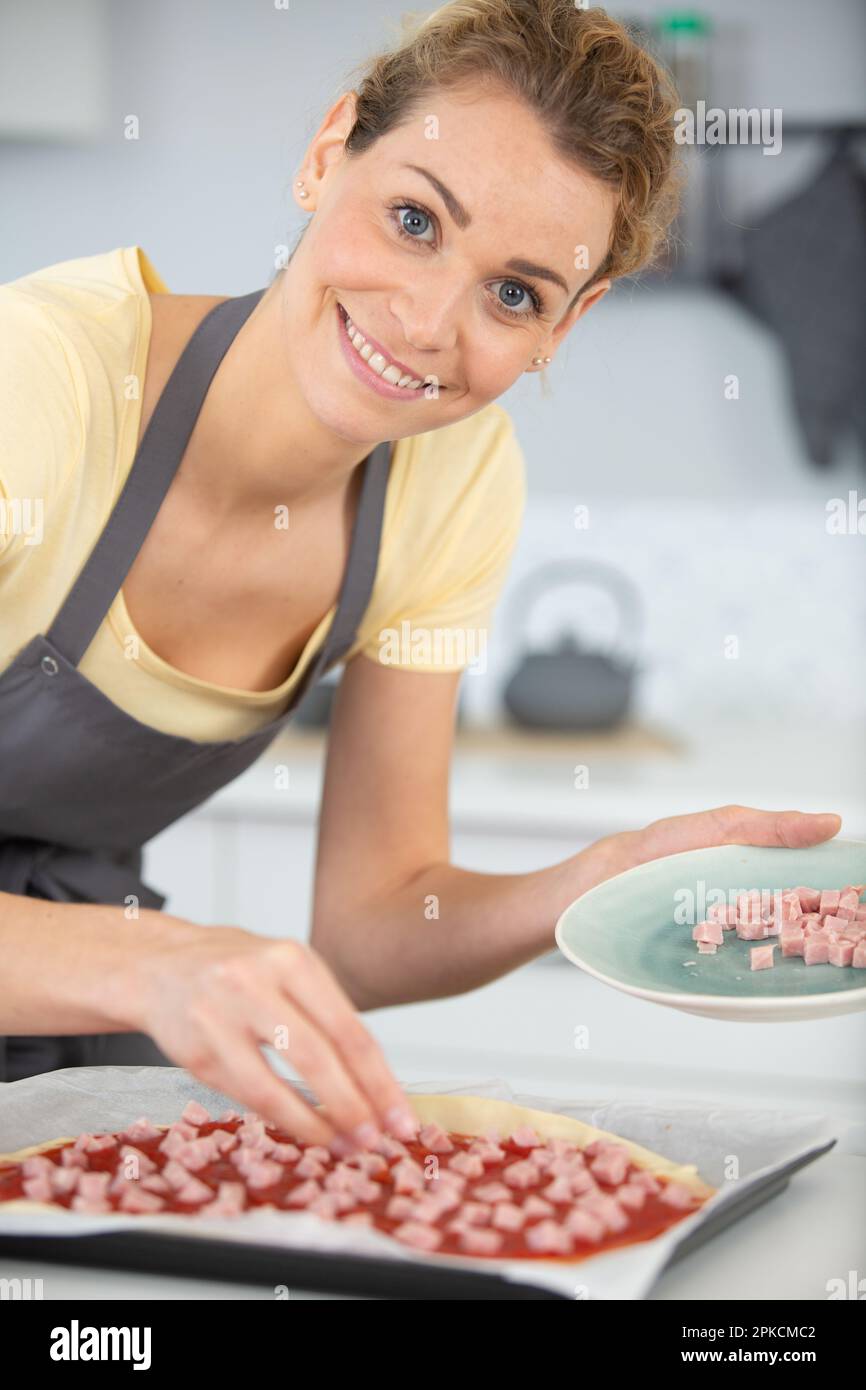 a young female making an italian style pizza at home Stock Photo - Alamy