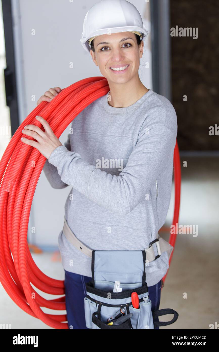 Female construction carrying pipes hi-res stock photography and images ...