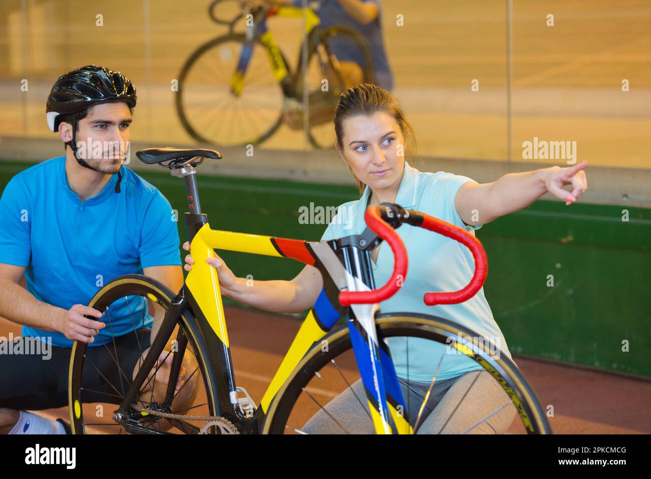 portrait of female bike coach pointing Stock Photo - Alamy
