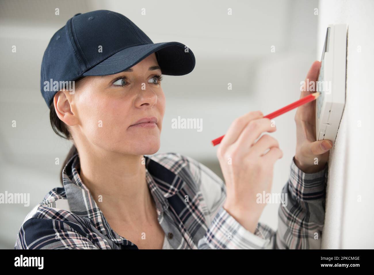 female worker checking the digital meter system she installed Stock ...