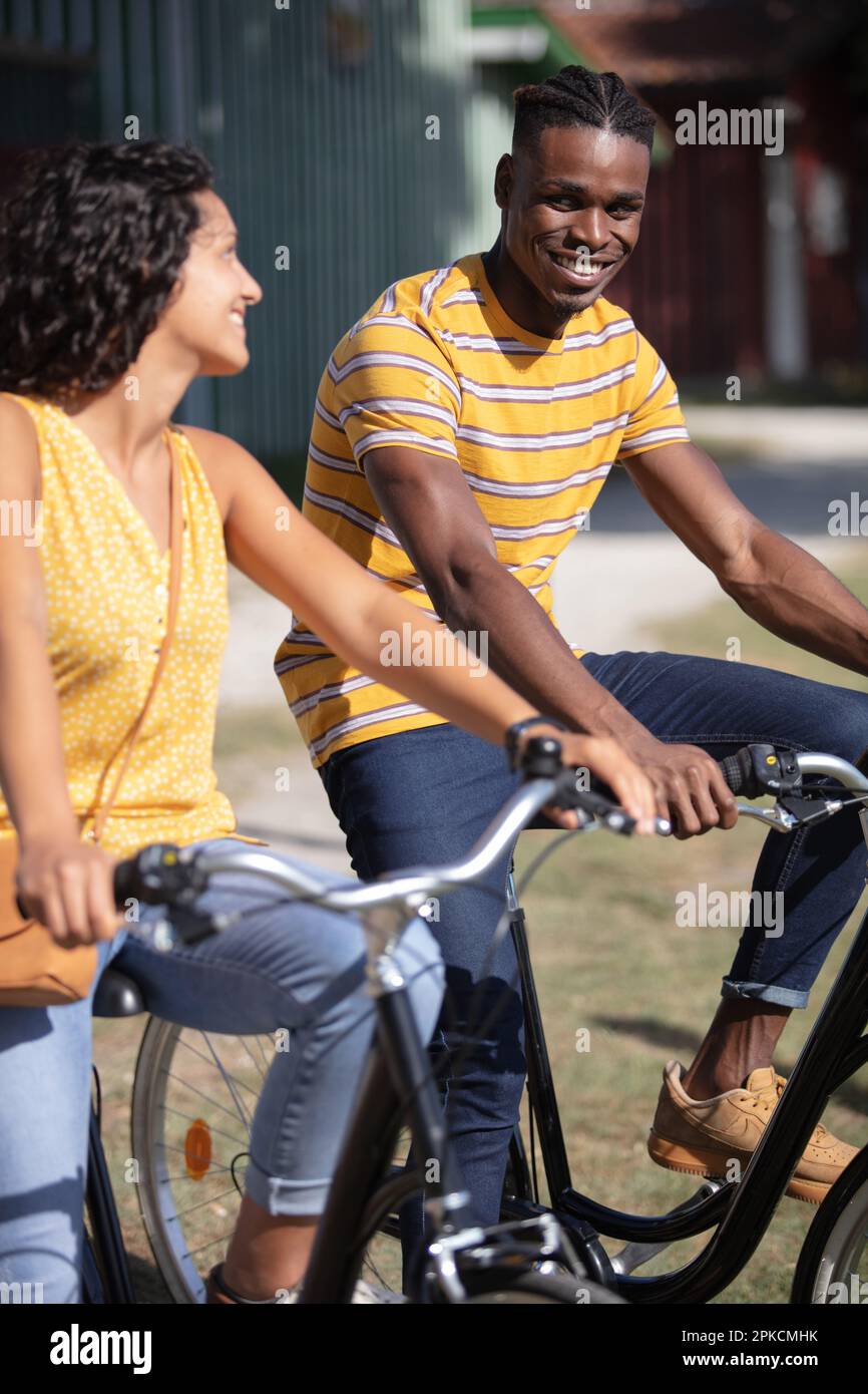 Young multiethnic couple bike hi-res stock photography and images - Alamy
