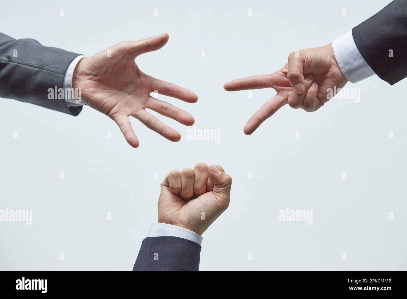 Hand of man in suit playing rock-paper-scissors Stock Photo - Alamy
