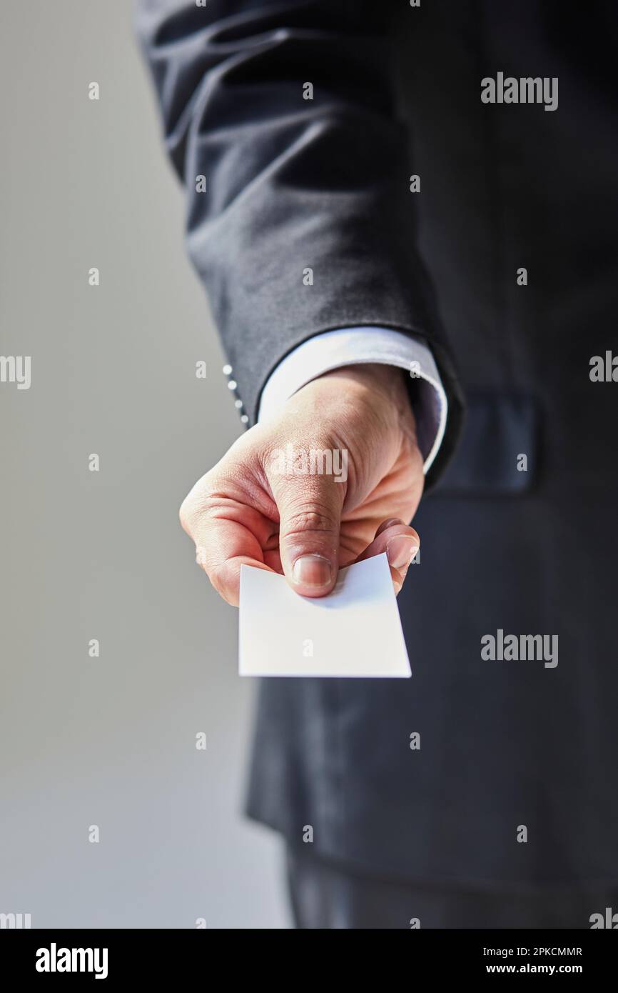 Two businessmen offering their business cards Stock Photo - Alamy