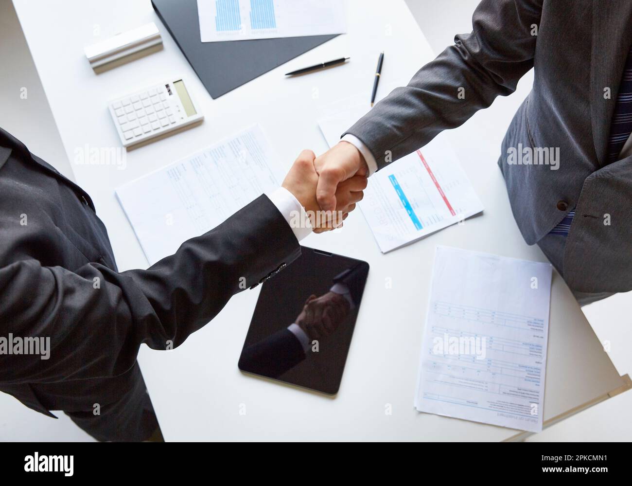 Two businessmen shaking hands Stock Photo - Alamy