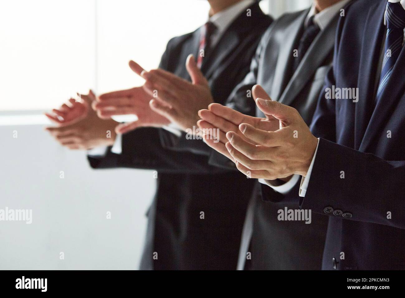 Man in suit clapping Stock Photo - Alamy
