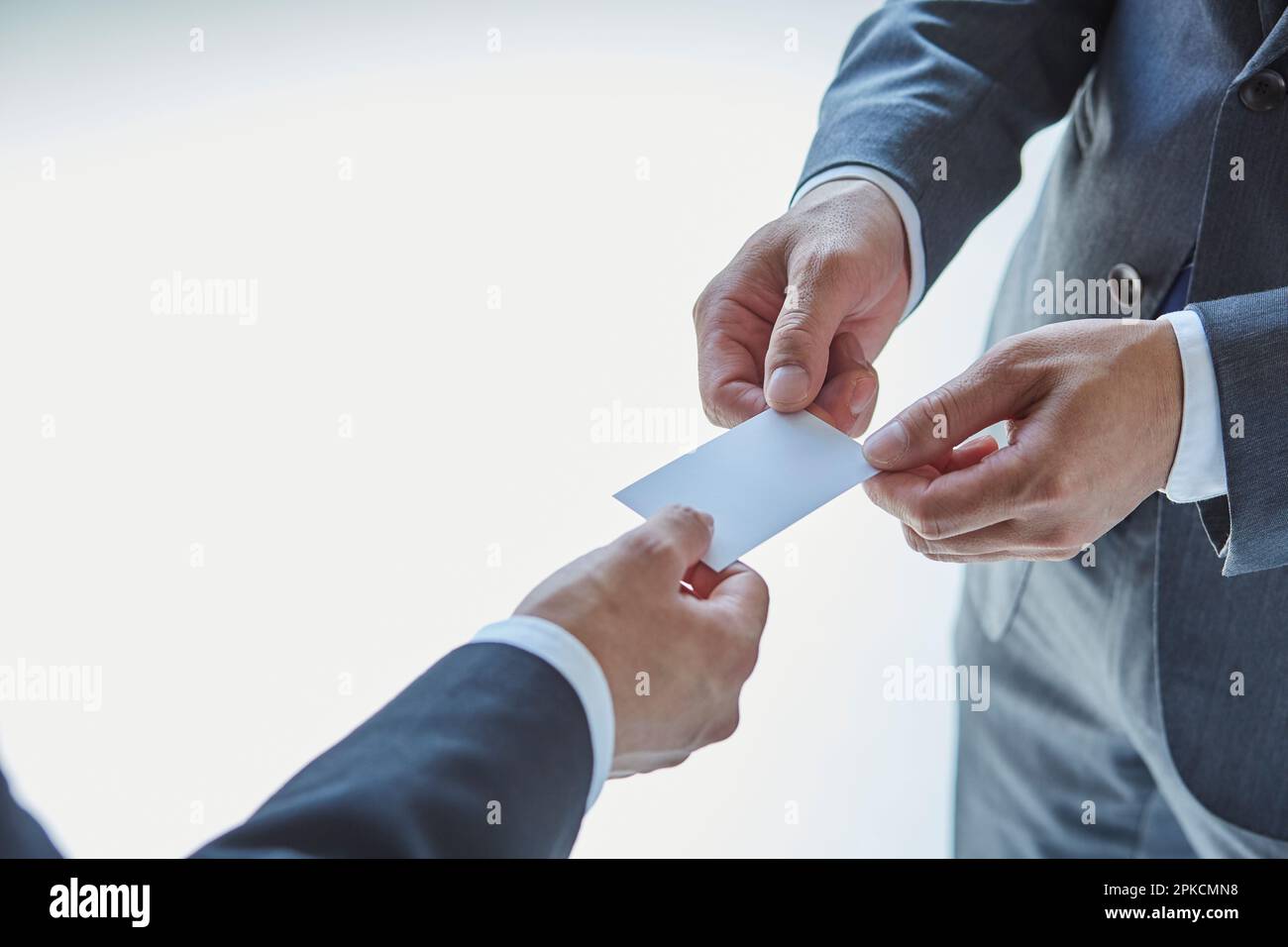 Two businessmen exchanging business cards Stock Photo - Alamy