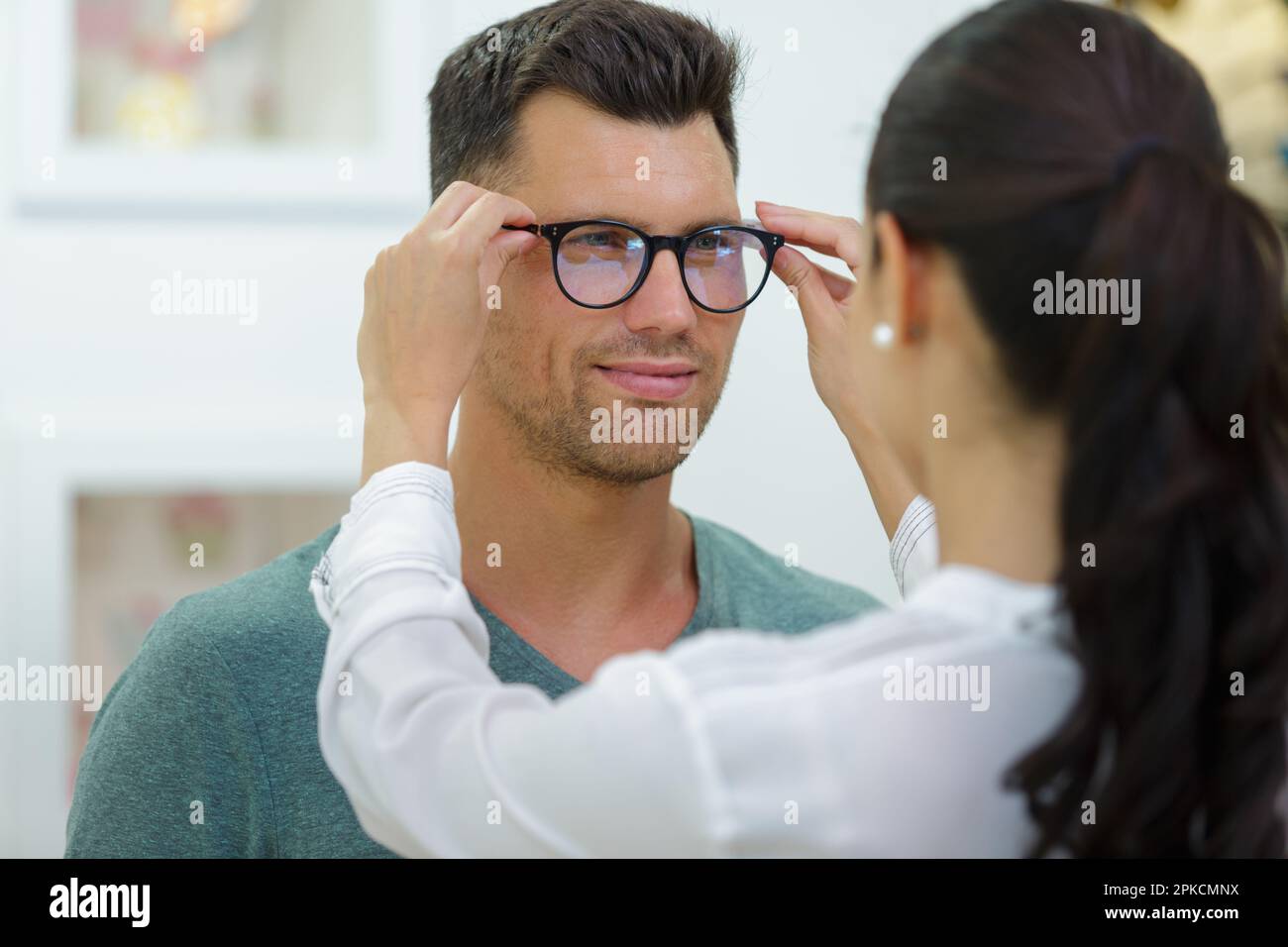 a man trying on glasses Stock Photo - Alamy