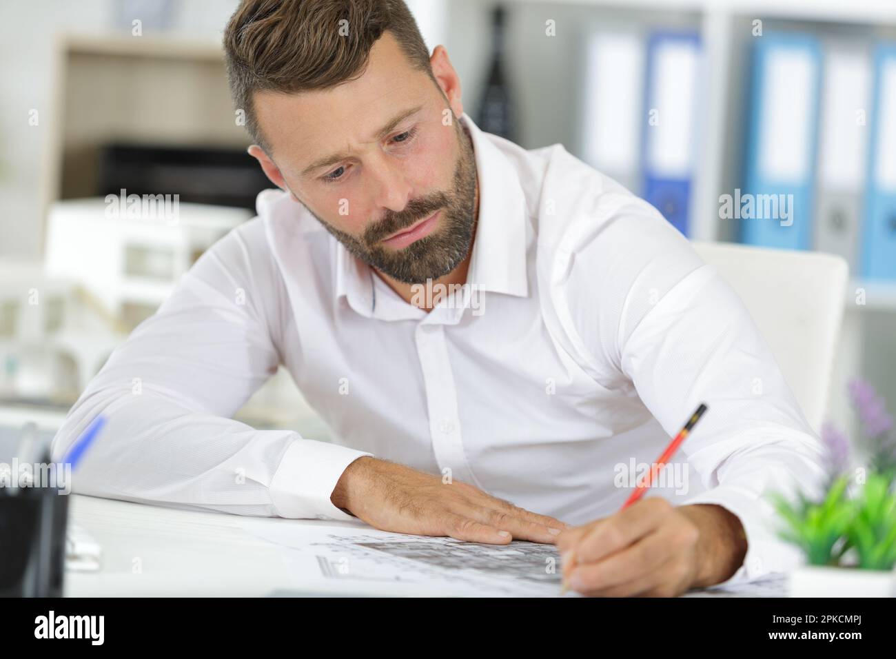 man architect draws a house plan Stock Photo - Alamy
