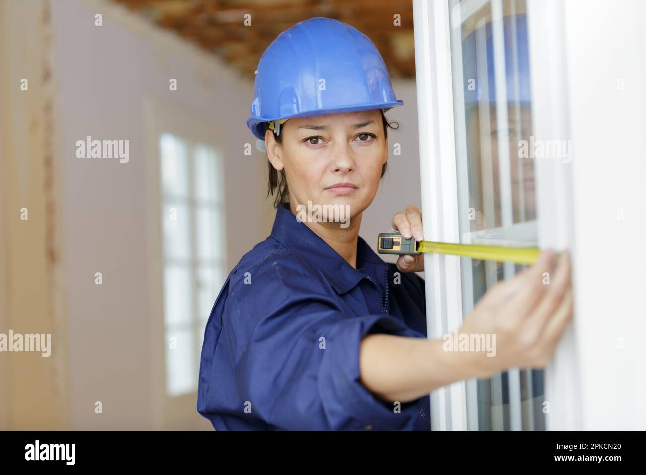 a female worker measuring window Stock Photo - Alamy