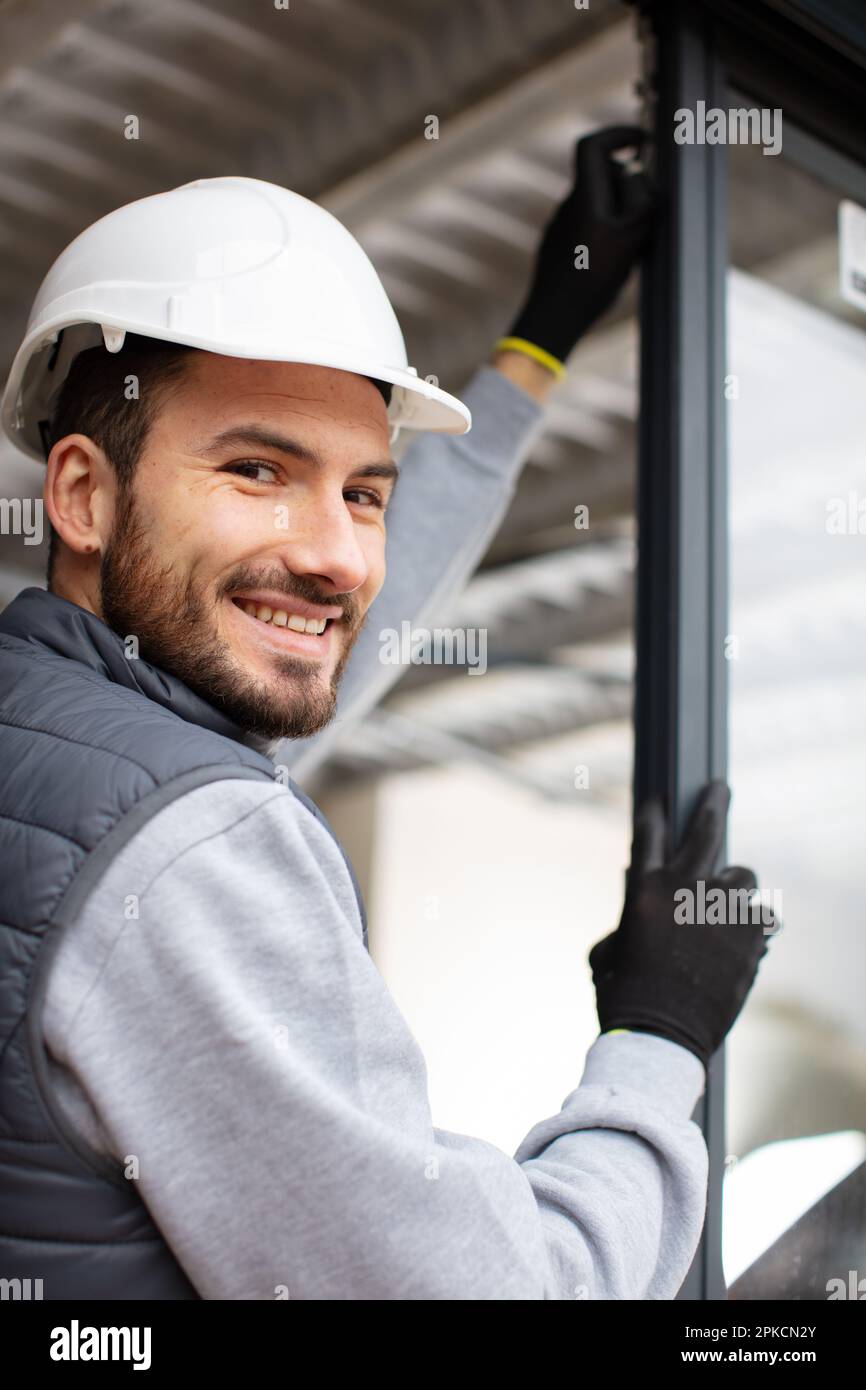 worker man installs windows and doors in a property Stock Photo - Alamy