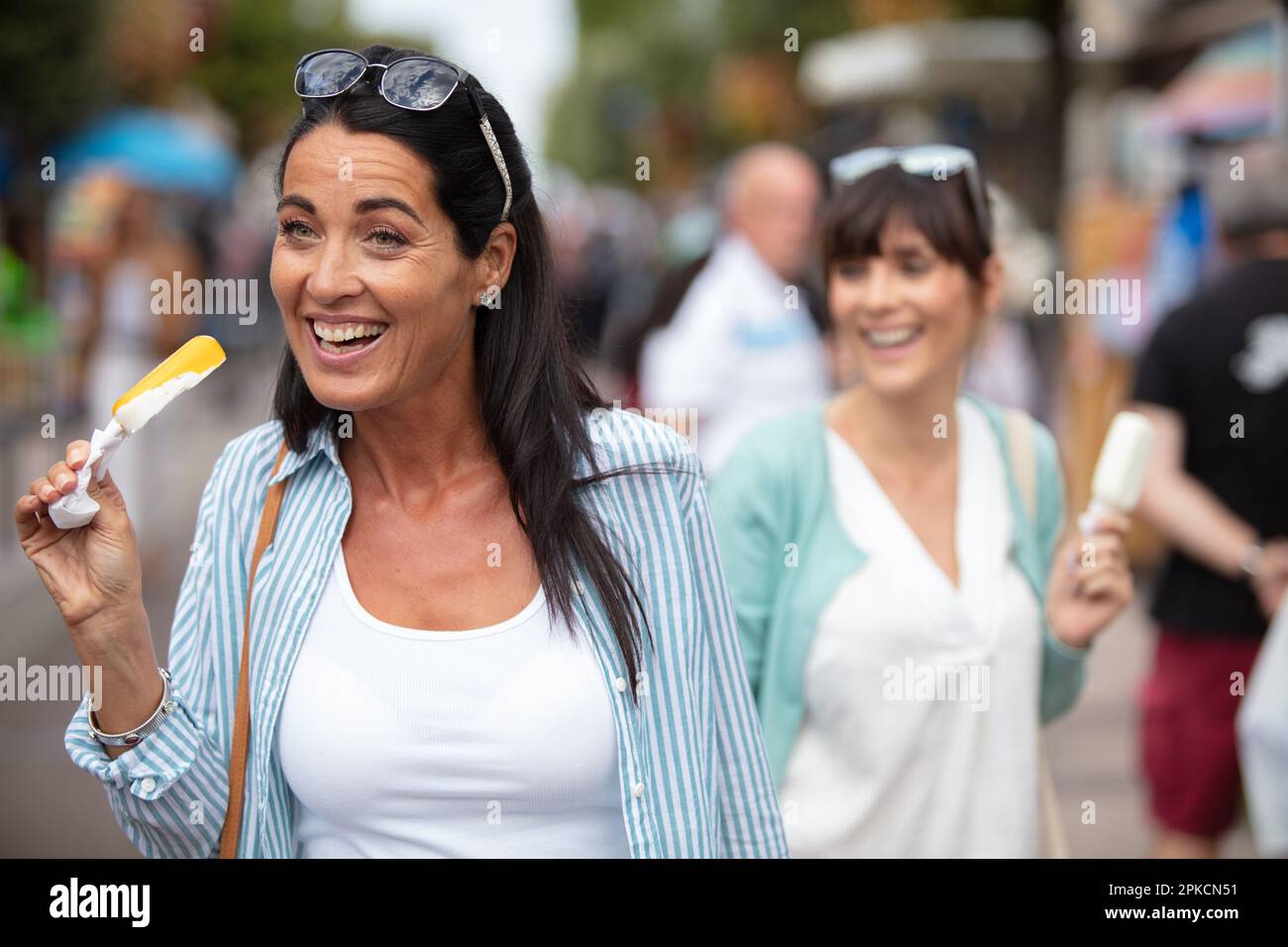 Two women eating icecream hi-res stock photography and images - Alamy