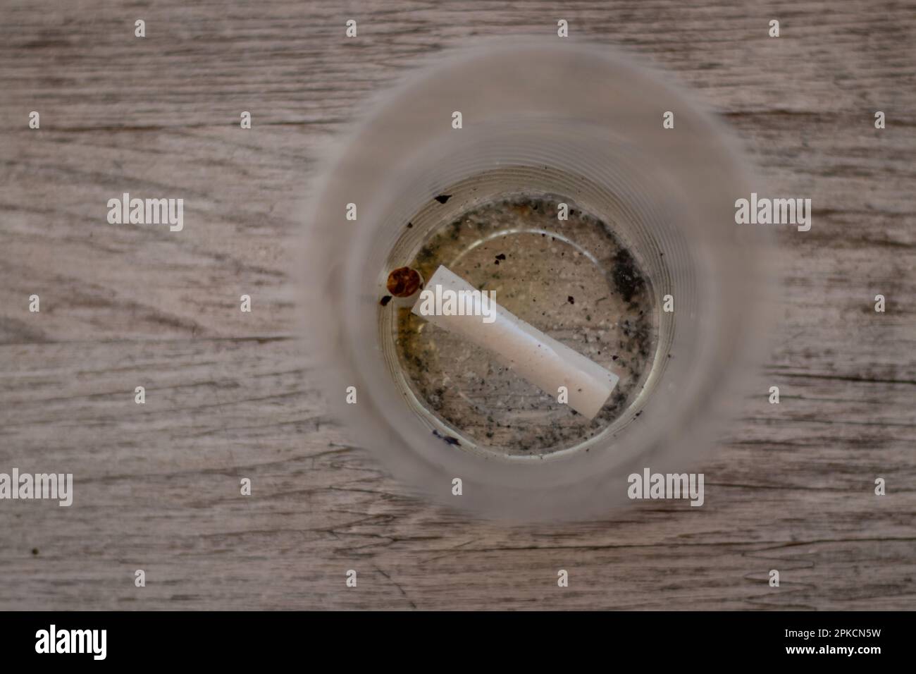 filter from a cigarette smoked floats in a plastic glass Stock Photo ...