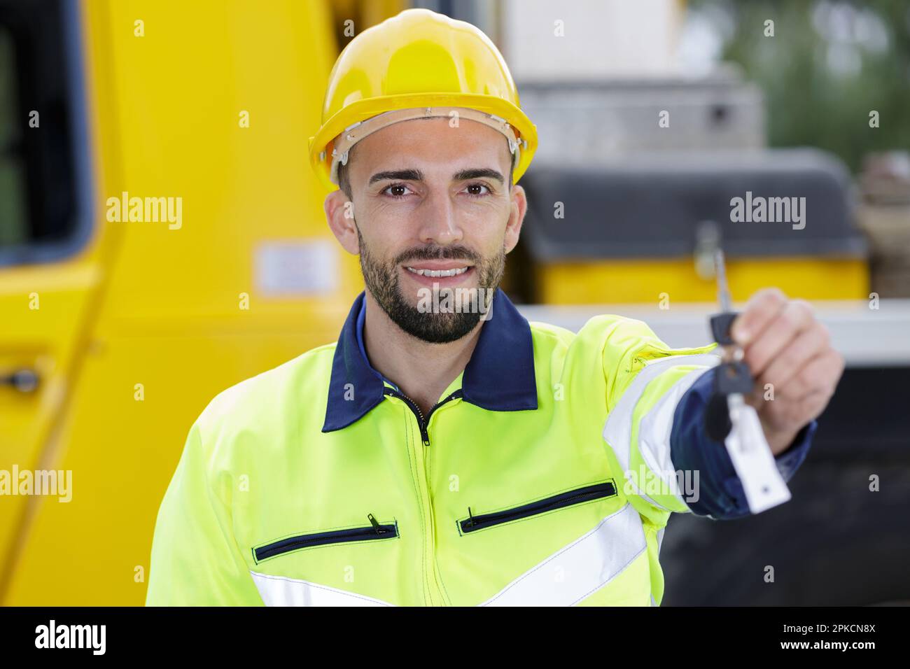 smiling civil engineer shows a key Stock Photo - Alamy