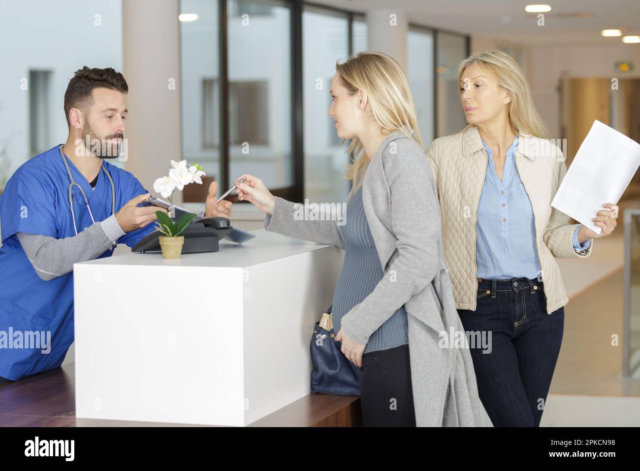 people in the hospital at the reception desk Stock Photo - Alamy