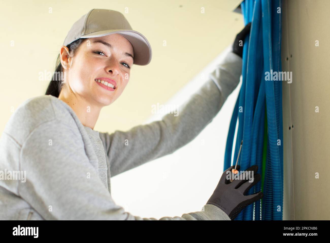 beautiful tradeswoman installing electrical wiring Stock Photo - Alamy